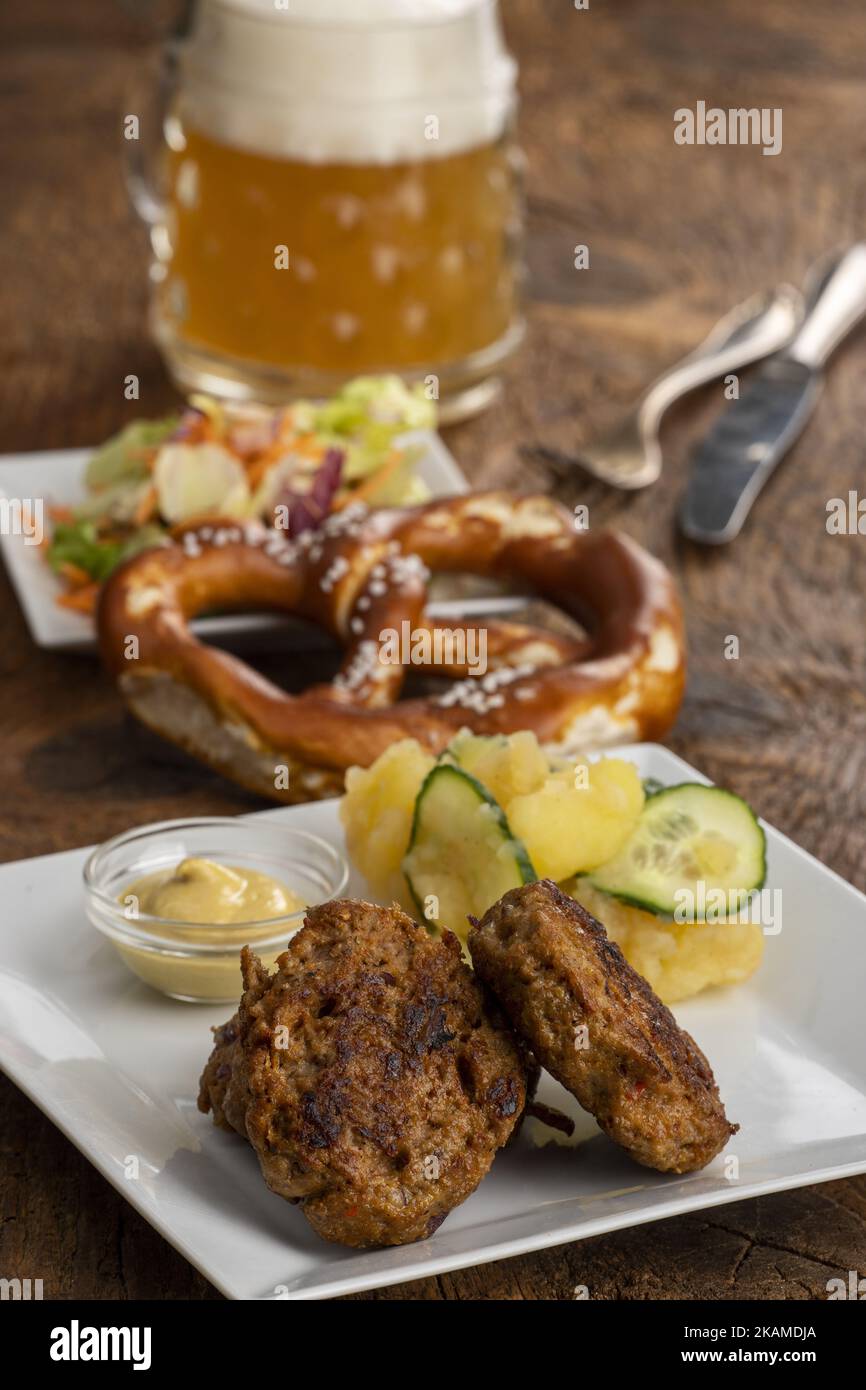 Bavarian Meat Patty With Potato Salad Stock Photo - Alamy
