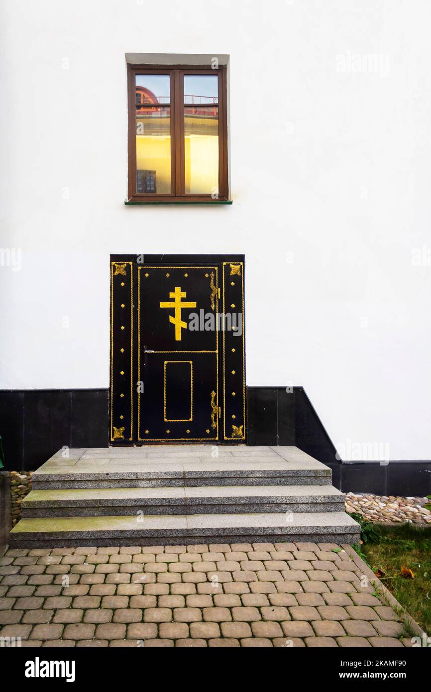 Black door with cross on church door and 3 steps of stairs Stock Photo ...