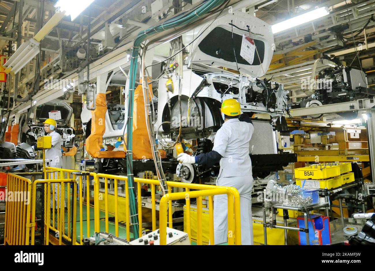 workers installing components to automobile vehicles at Toyota Motor ...