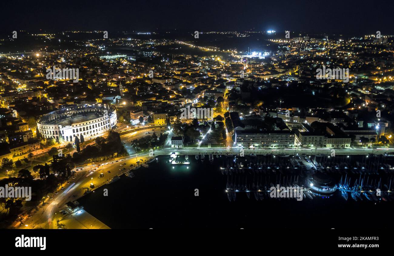 An aerial shot of the beautiful city Pula at night in Croatia Stock ...