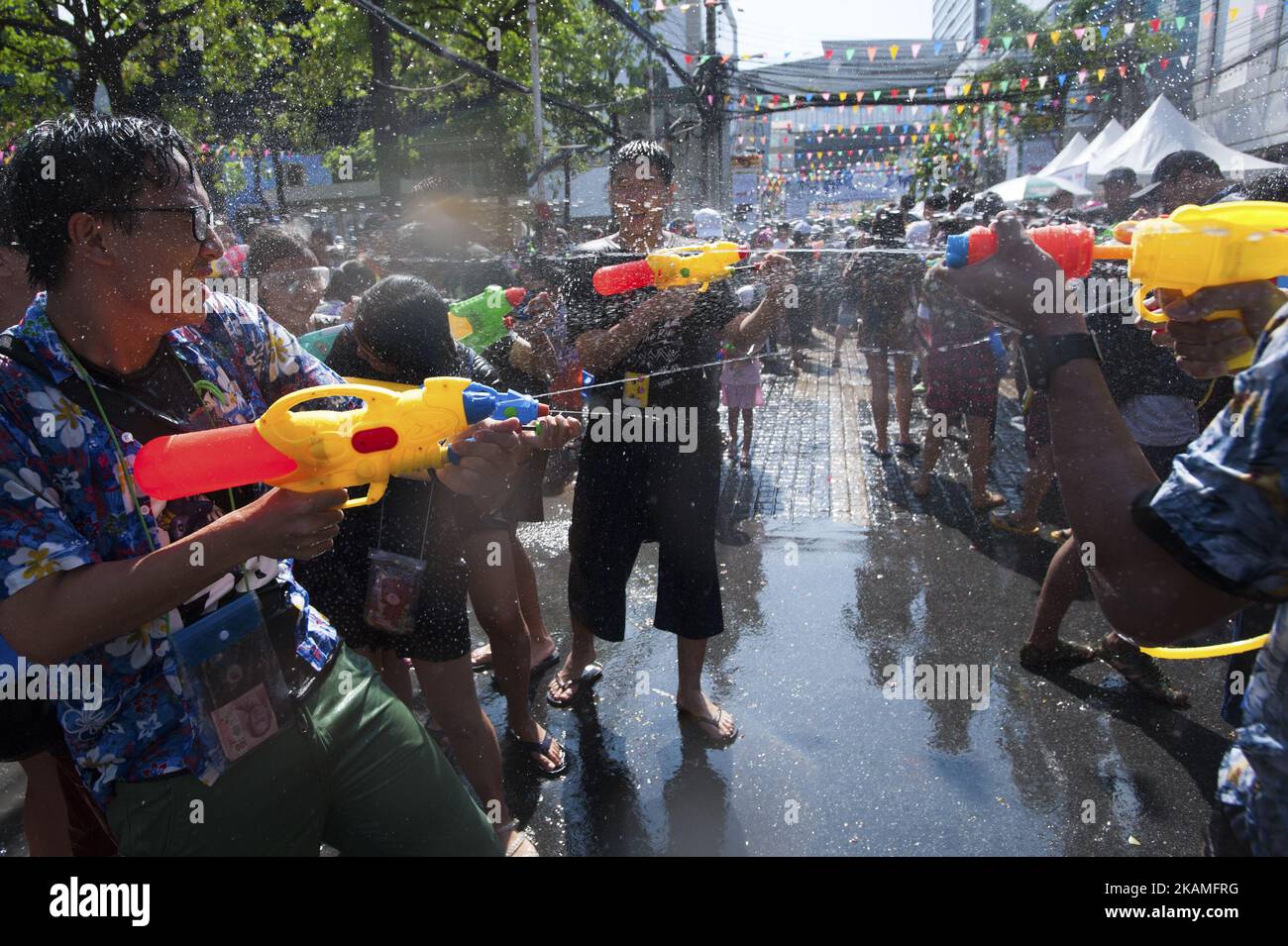 Revellers reacts during a water fight at Songkran Festival celebrations in Bangkok, Thailand, on ...