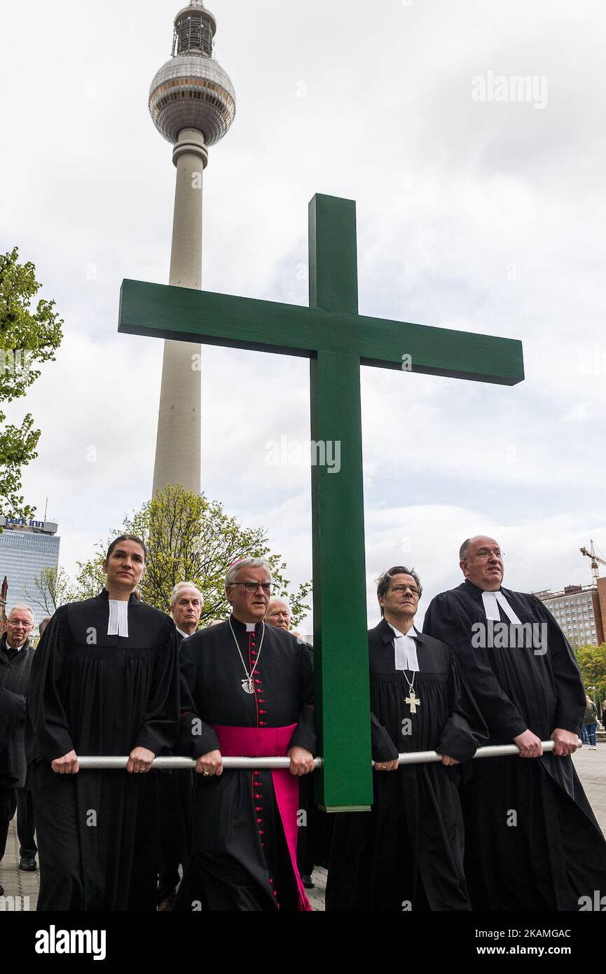 Protestant pastors carry a cross during a procession through the city ...