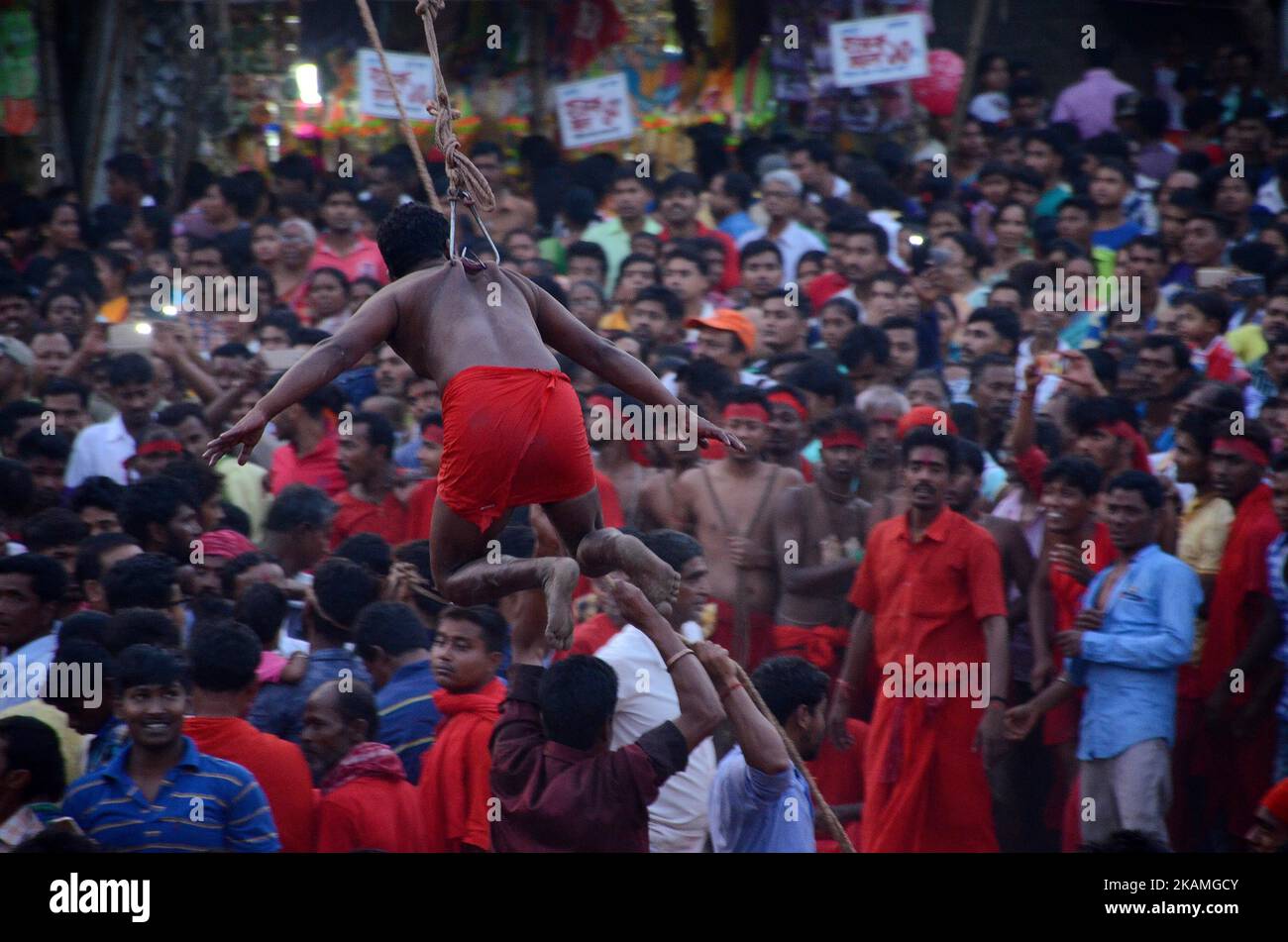 Indian Hindu devotee hanged from rope with iron hook during the Gajan ...