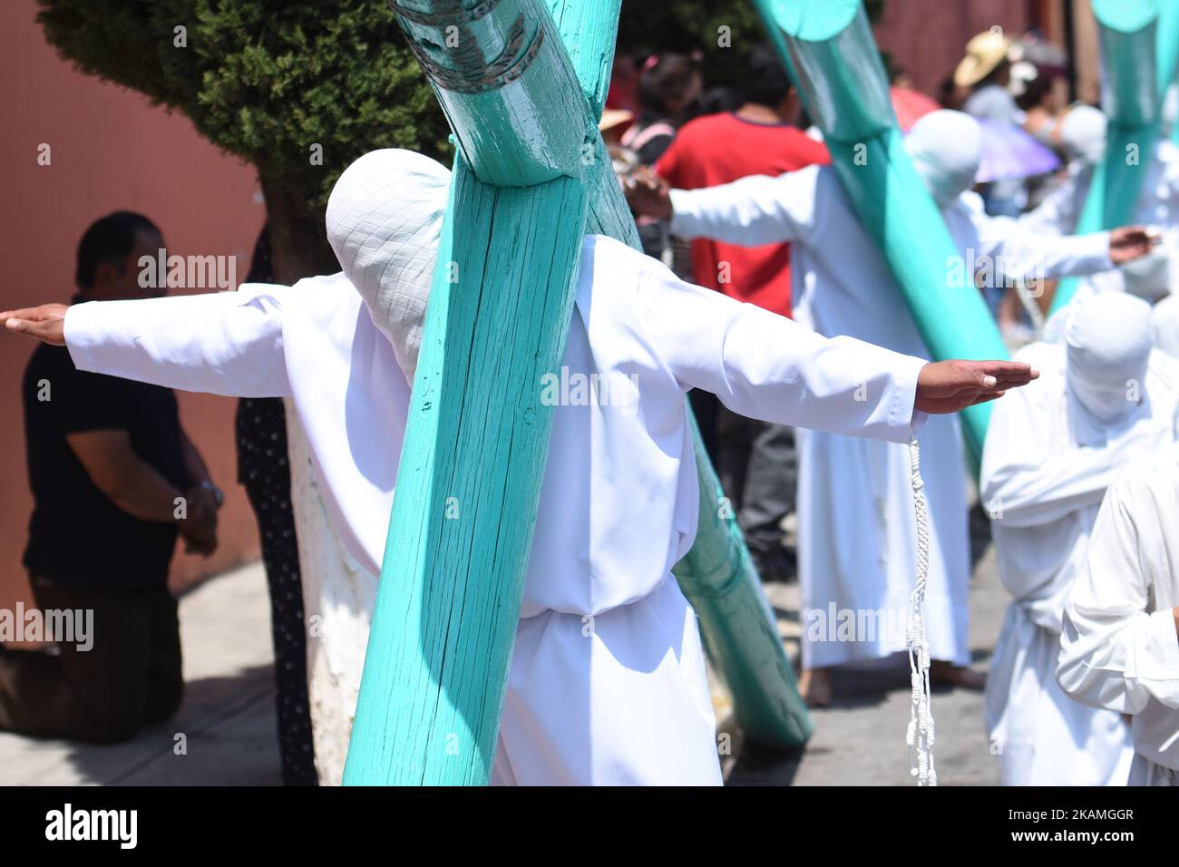 Penitents are seen Lifting a wooden cross during 'Cruciferos' religious ...