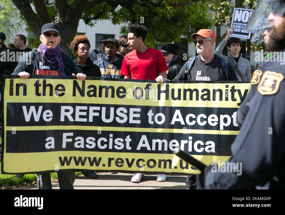 Anti-fascist protesters hold a sign and chant during a free speech ...