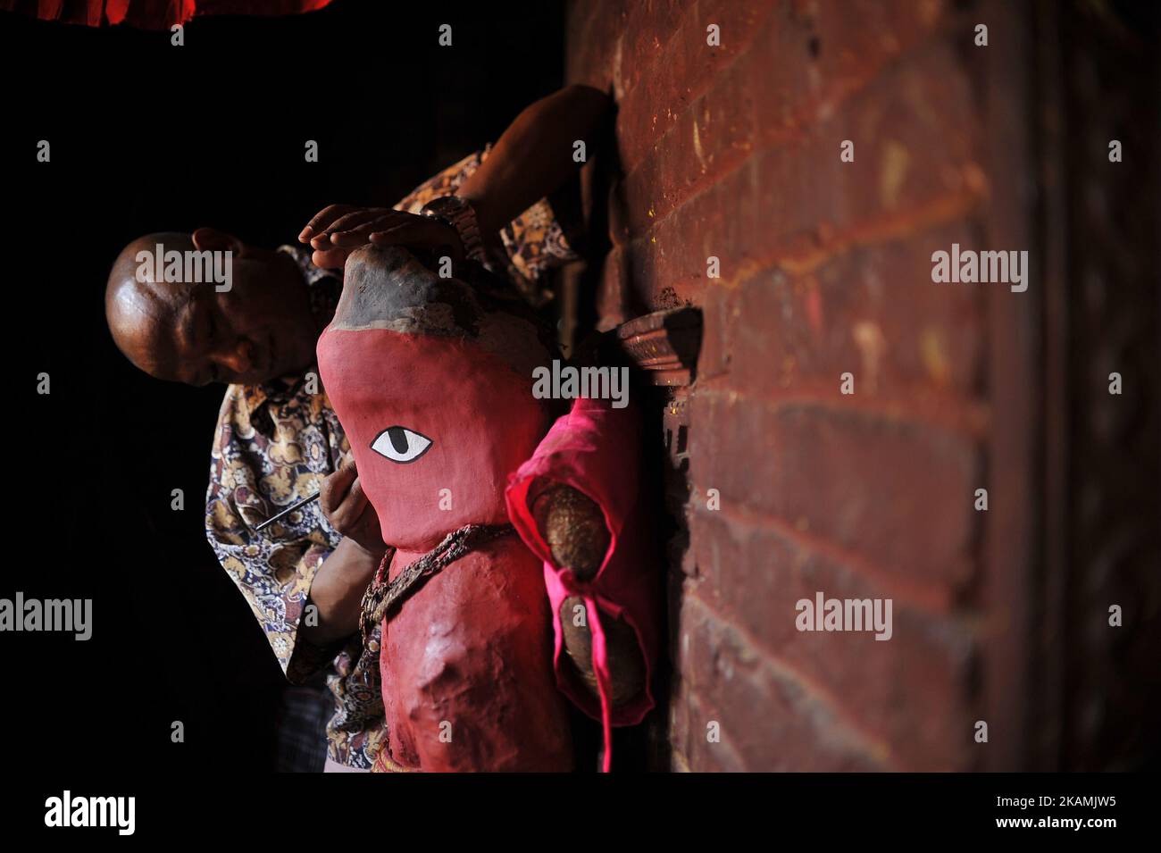 GHAMBIR NEKHU, 46 yrs old, priest painting on Statue of Idol Rato ...