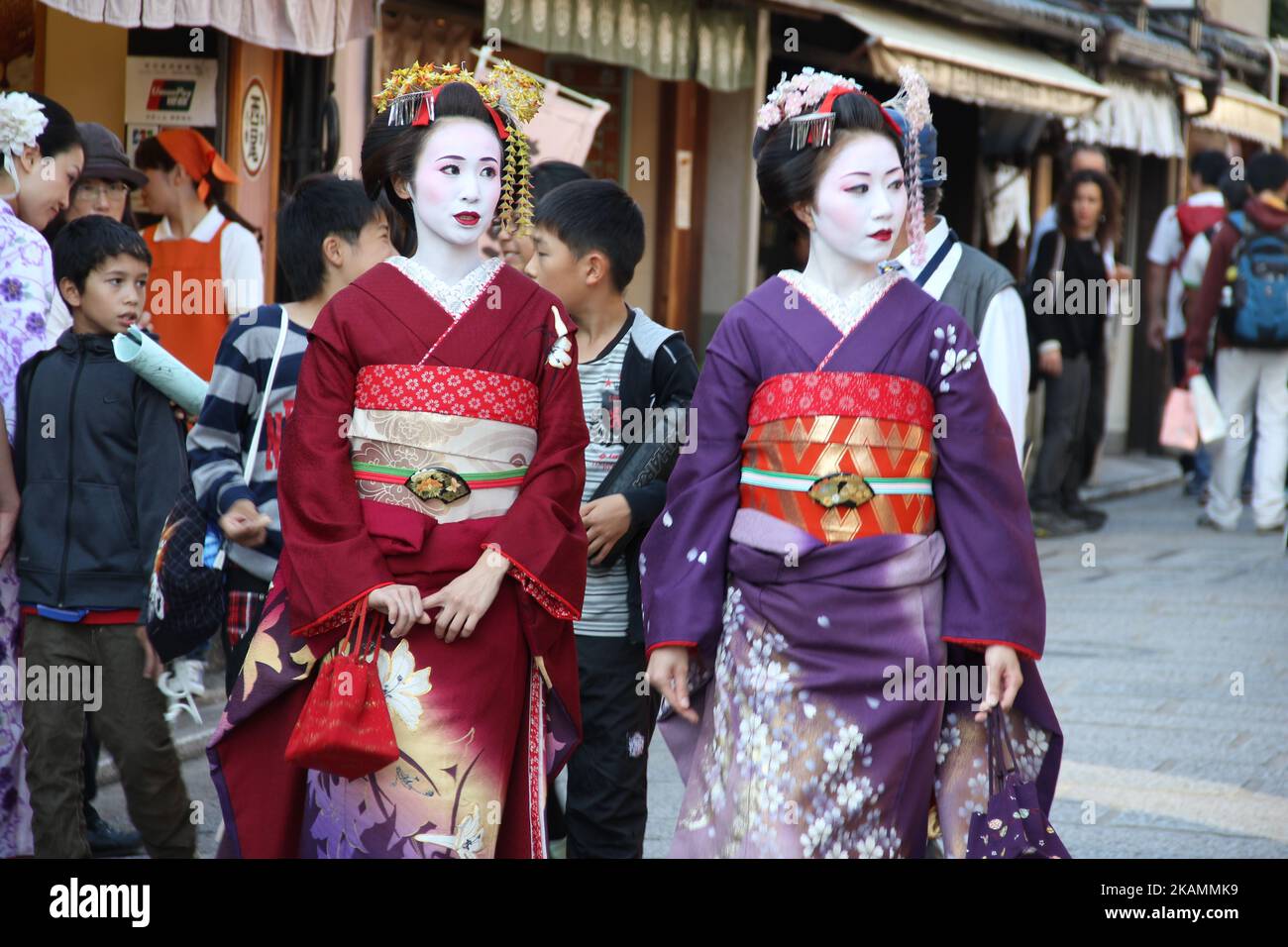 Asian women wearing dressed up as geishas walking through the streets ...