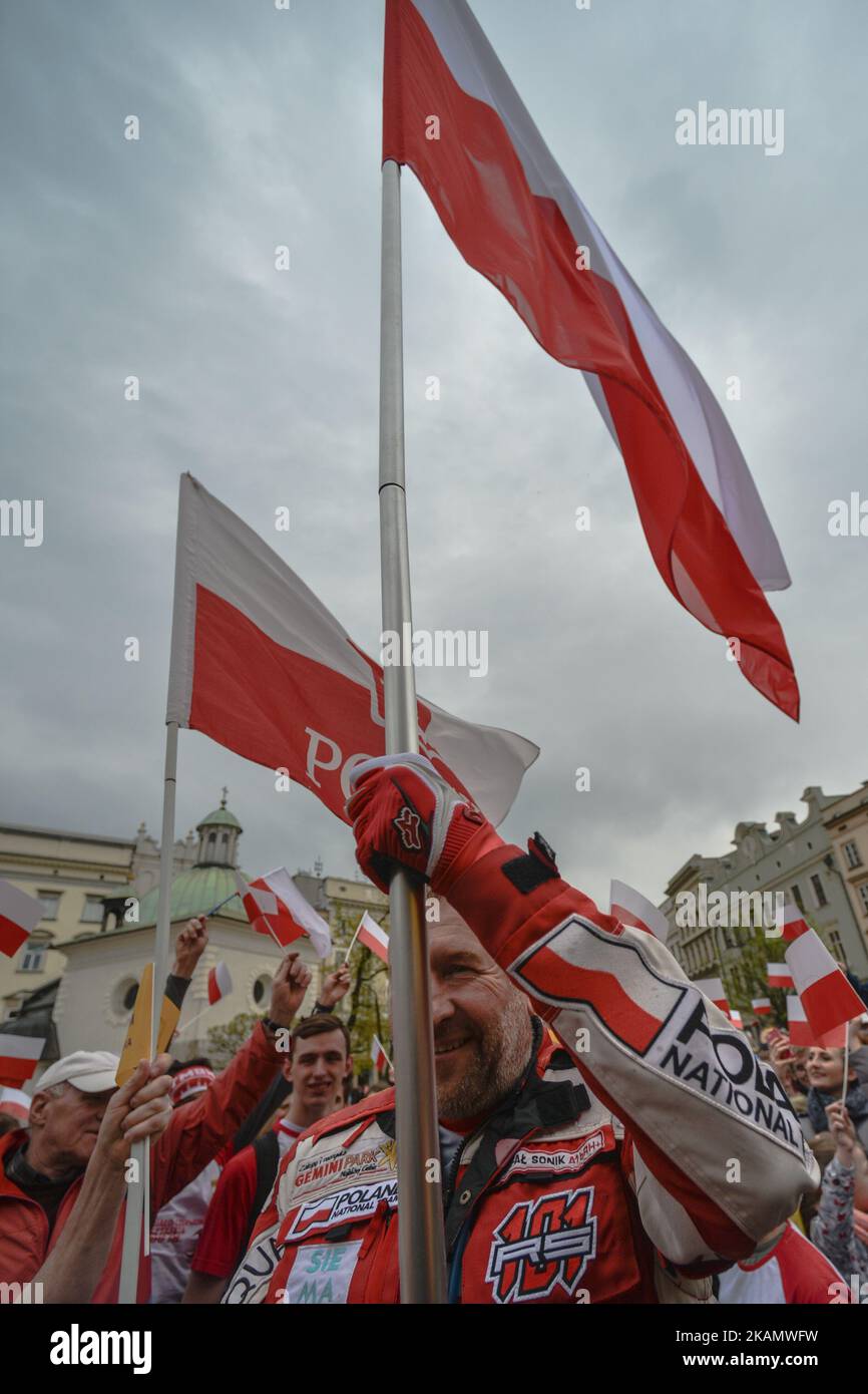 Rafal Sonik, a Polish quad rally driver, carries the Polish national ...