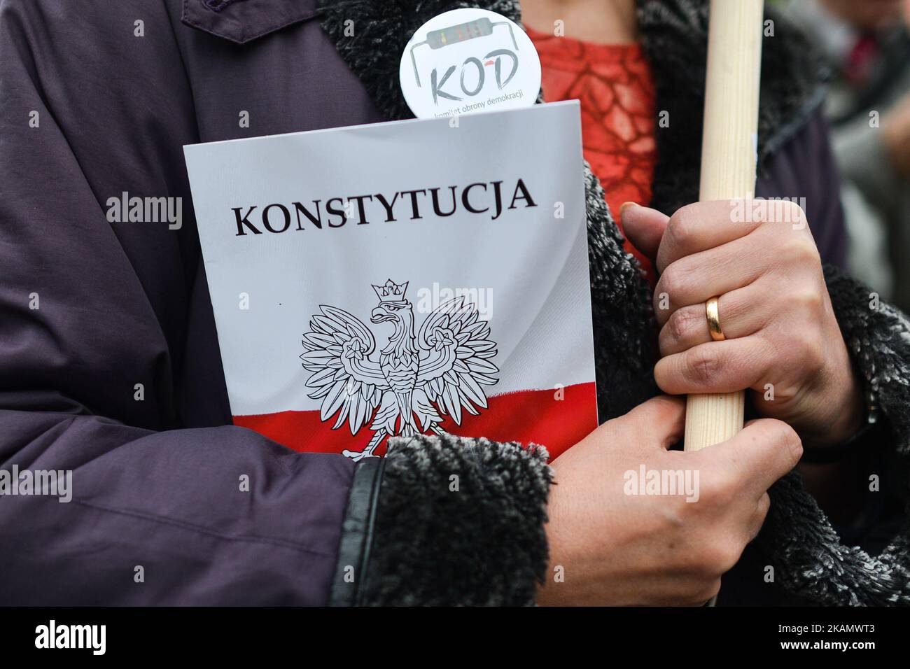 A person holds a copy of the Polish Constitution during the patriotic ...