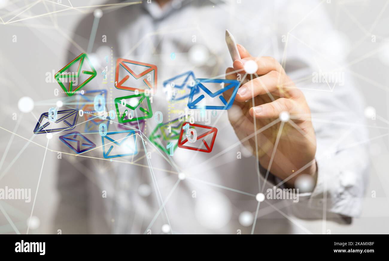 A hand pointing with a pencil at mail communication blockchain floating ...