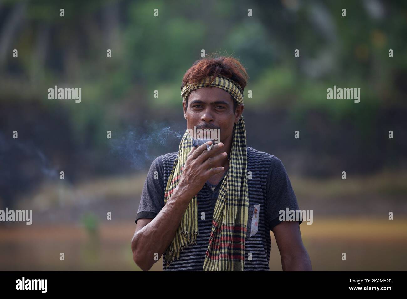 A portrait of an Indian man smoking Stock Photo - Alamy