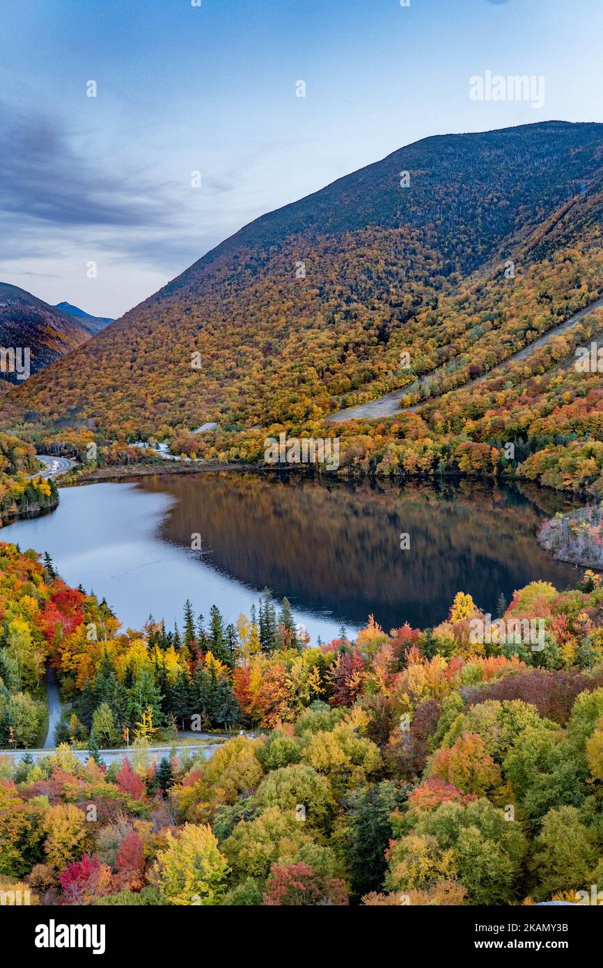 A vertical shot of Echo lake and colorful fall foliage in Franconia ...
