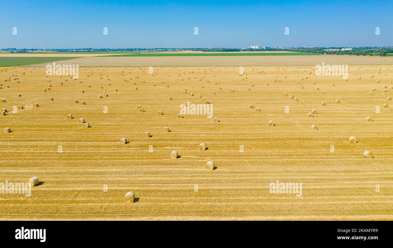 Above view on tractor as pulling round baler, machine that rolls up the ...