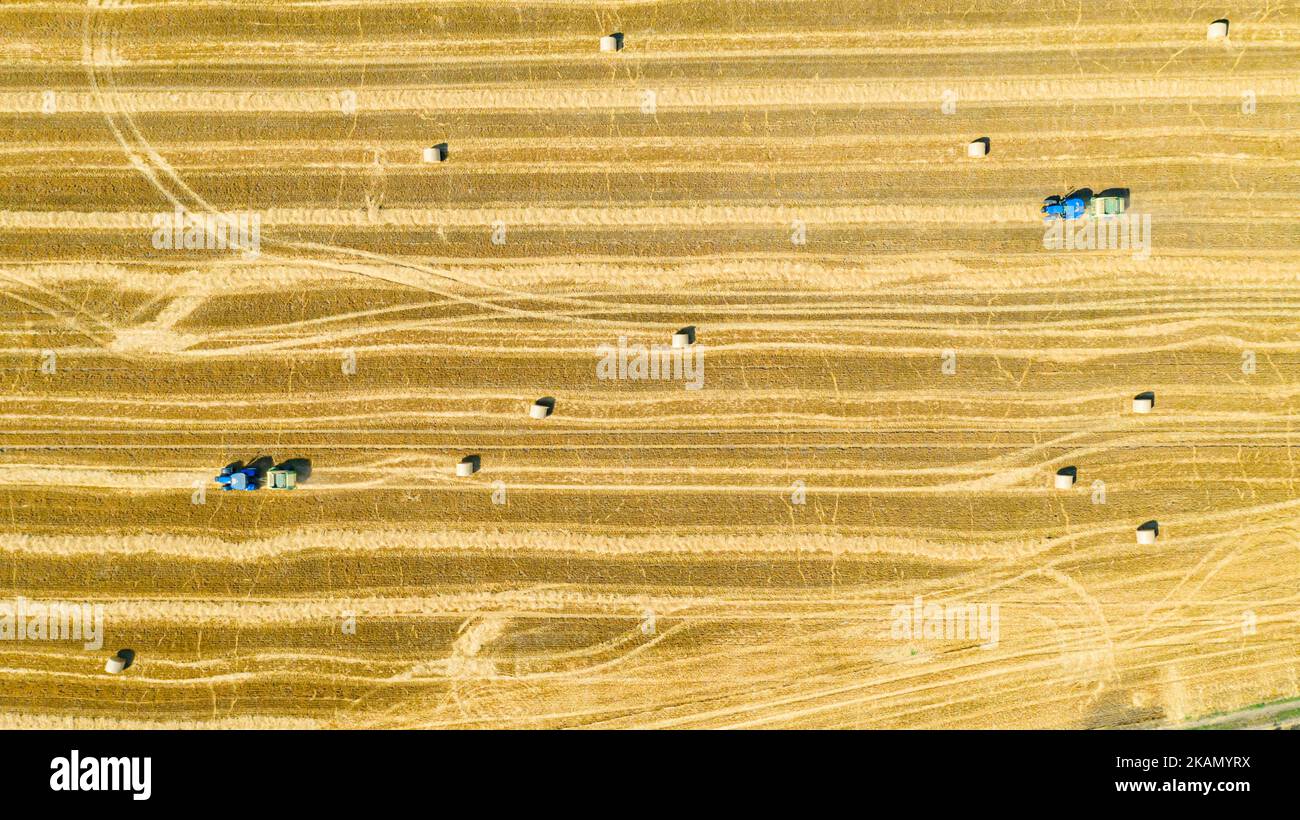 Above top view on two tractors as they pulling round baler, machines ...