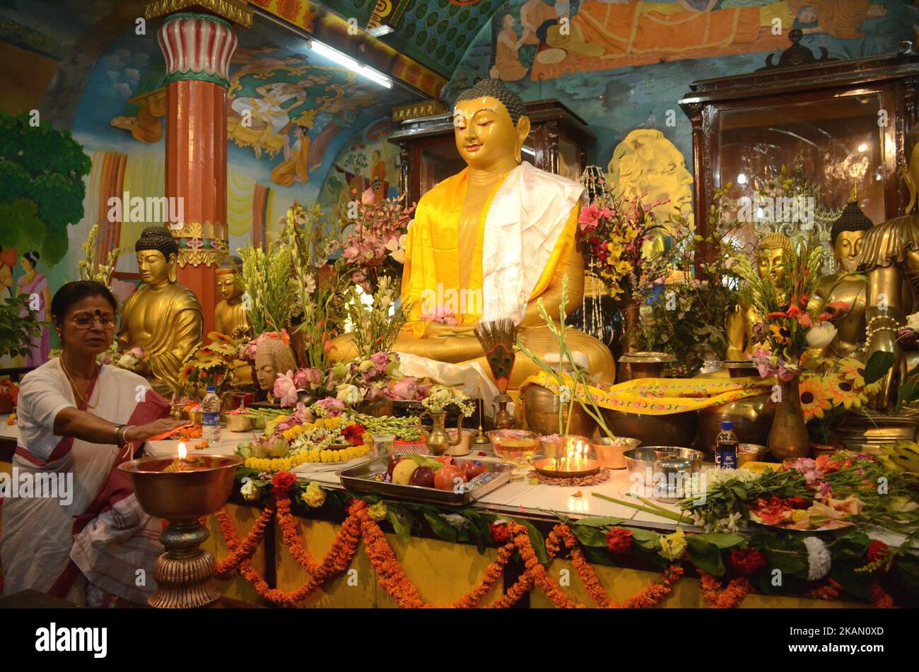Indian Buddhist devotee praying at the Buddhist temple during Buddha ...
