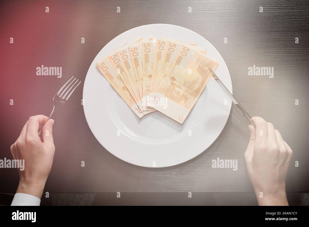 Money on a plate with a fork and knife. Euro banknotes. Wealth and the ...