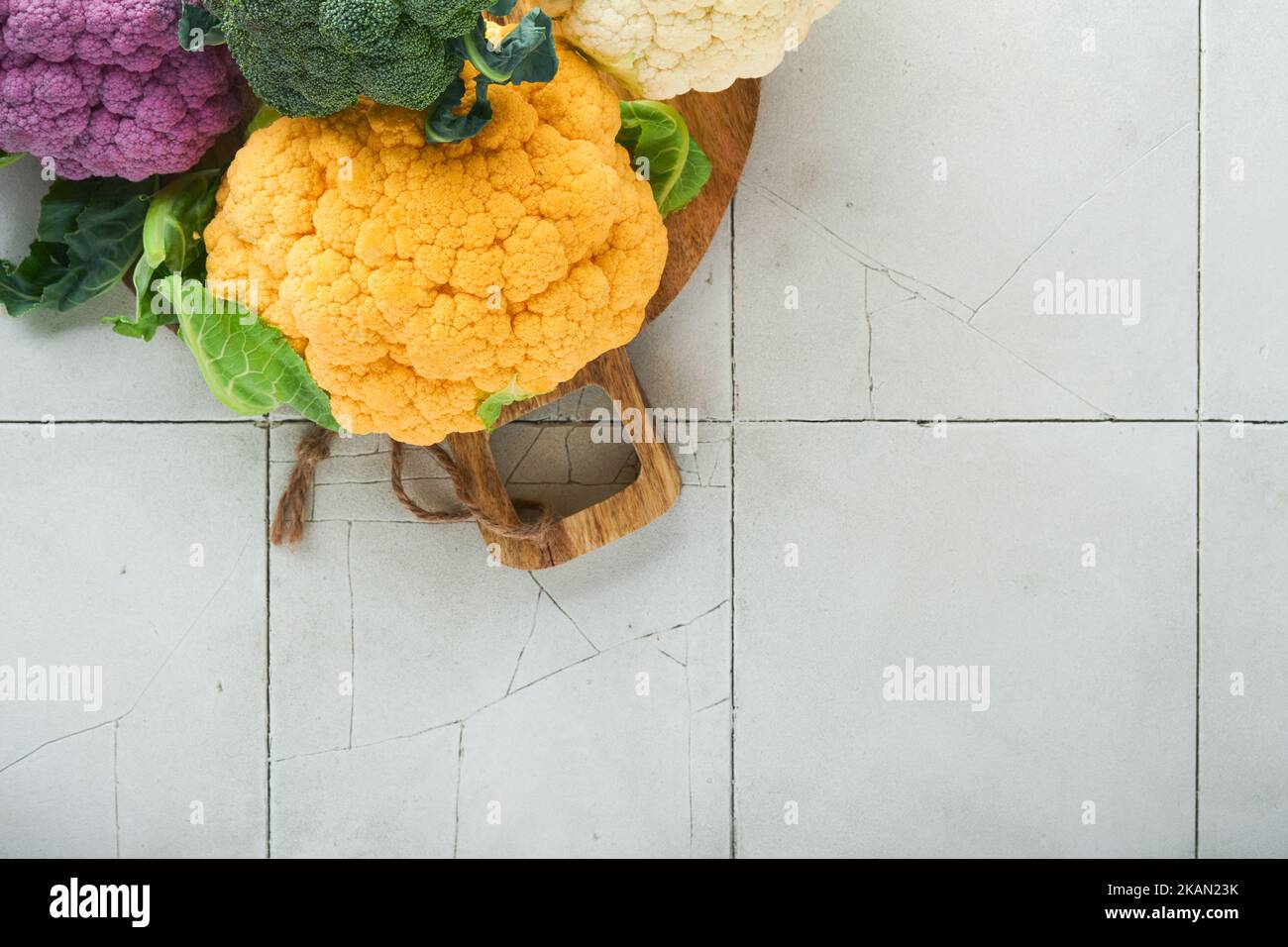 Colorfu cauliflower. Various sort of cauliflower on stone tiles gray ...