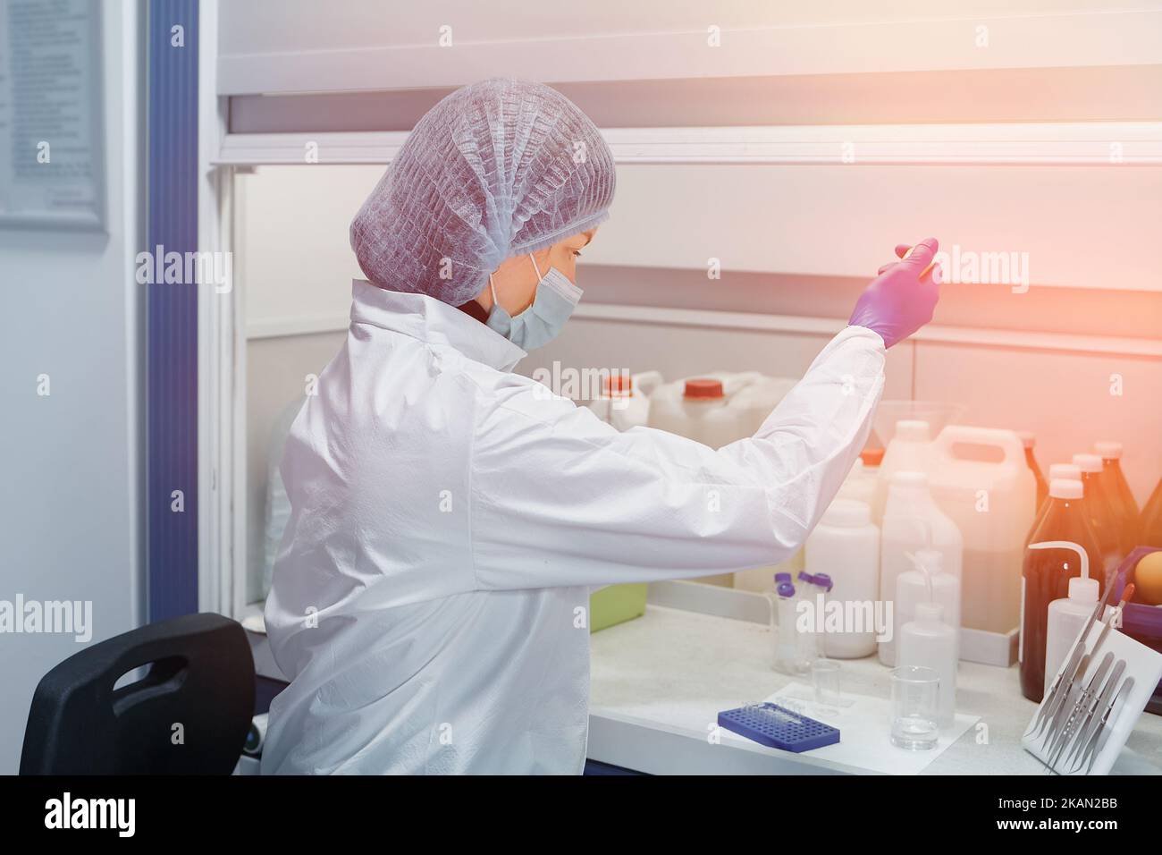 Scientist or laboratory assistant holding a test tube in a scientific ...