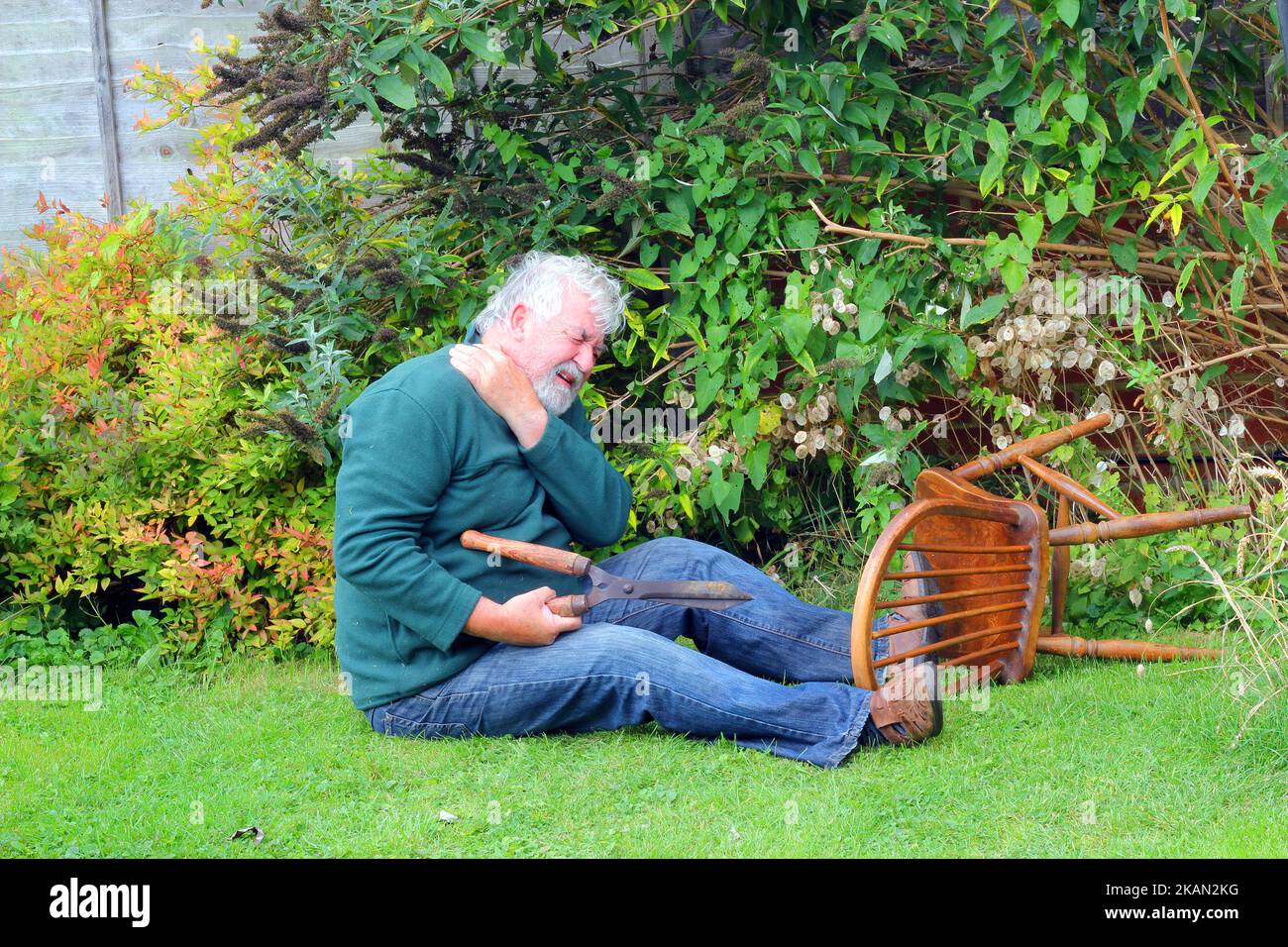 Senior man gardening and had an accident. Fallen over. Accident. Sharp ...