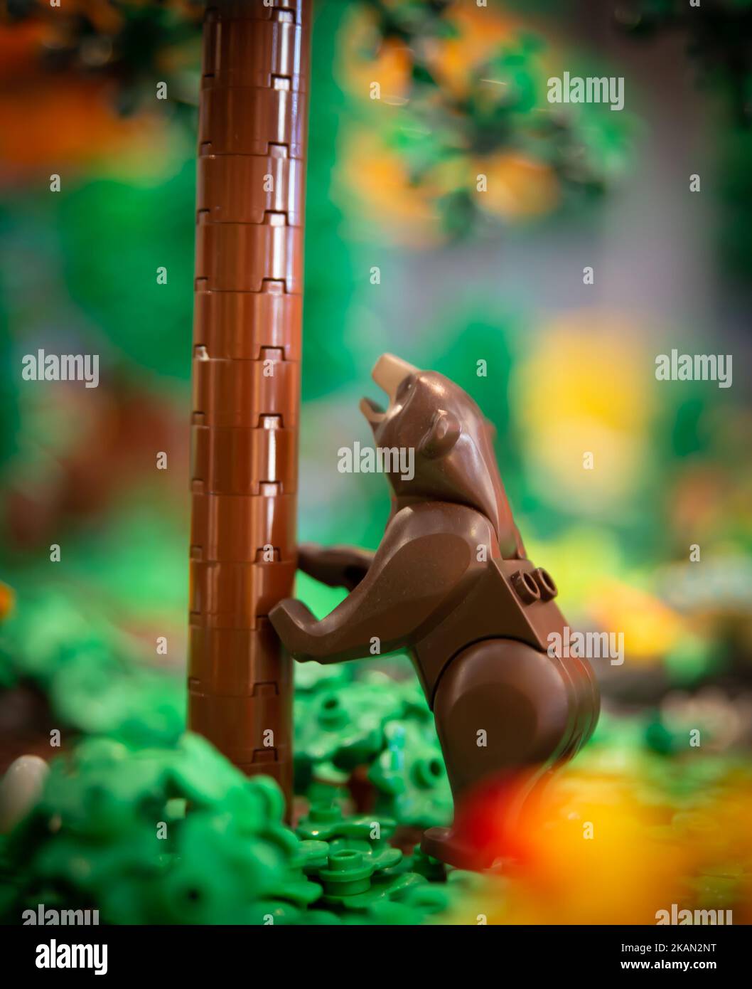 A bear toy figure climbing a tree, vertical shot Stock Photo - Alamy