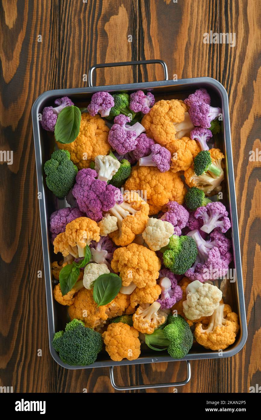 Colorful cauliflower. Cauliflower cut into small pieces in iron pan on ...