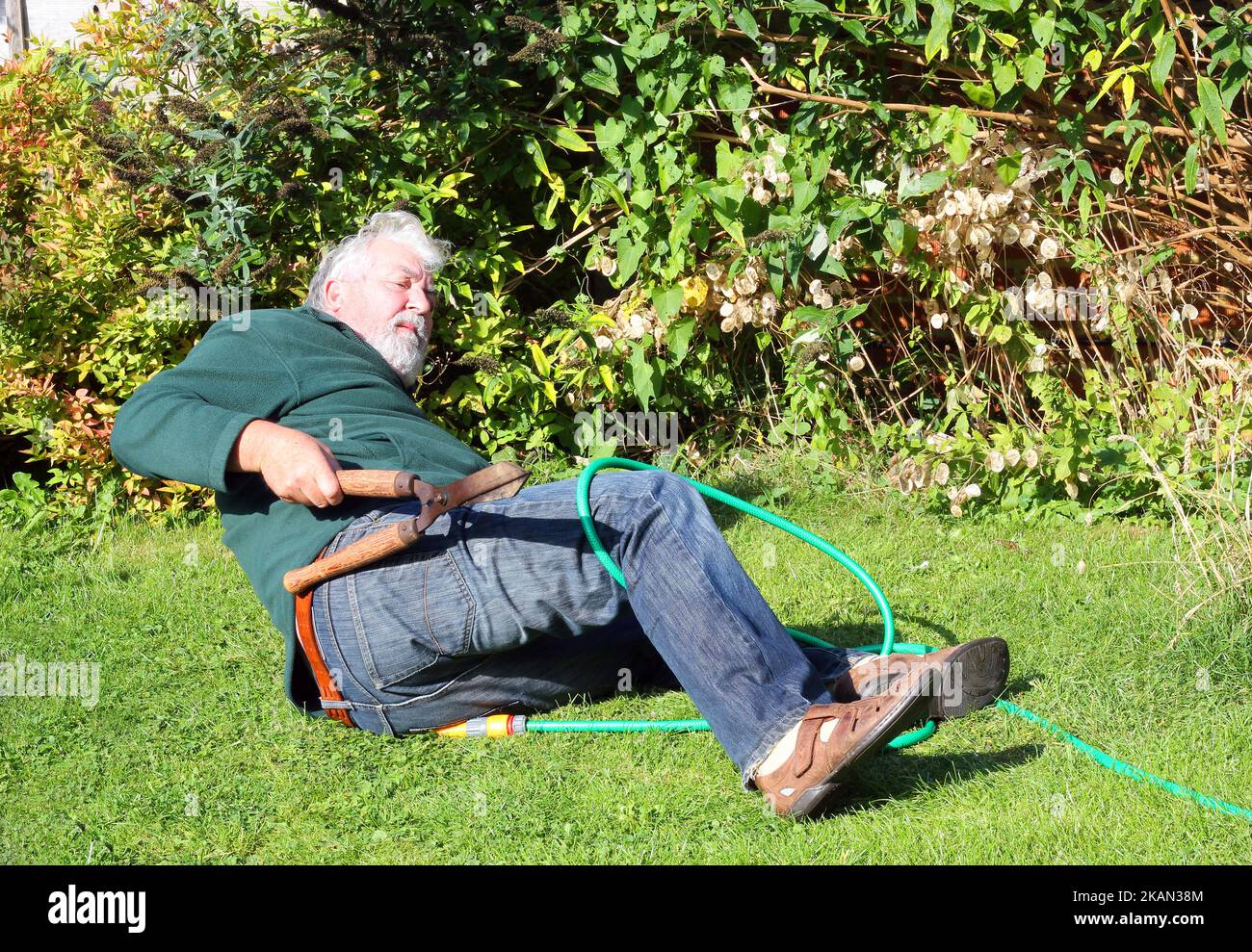 Senior man gardening and had an accident. Fallen over. Accident. Sharp ...