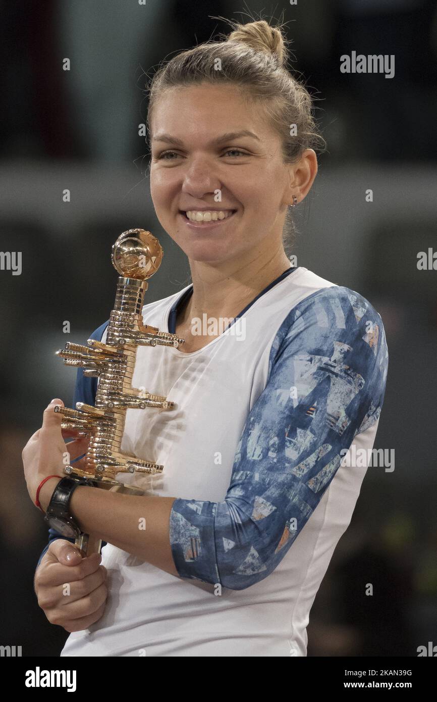Romanian tennis player Simona Halep poses with her trophy as she ...