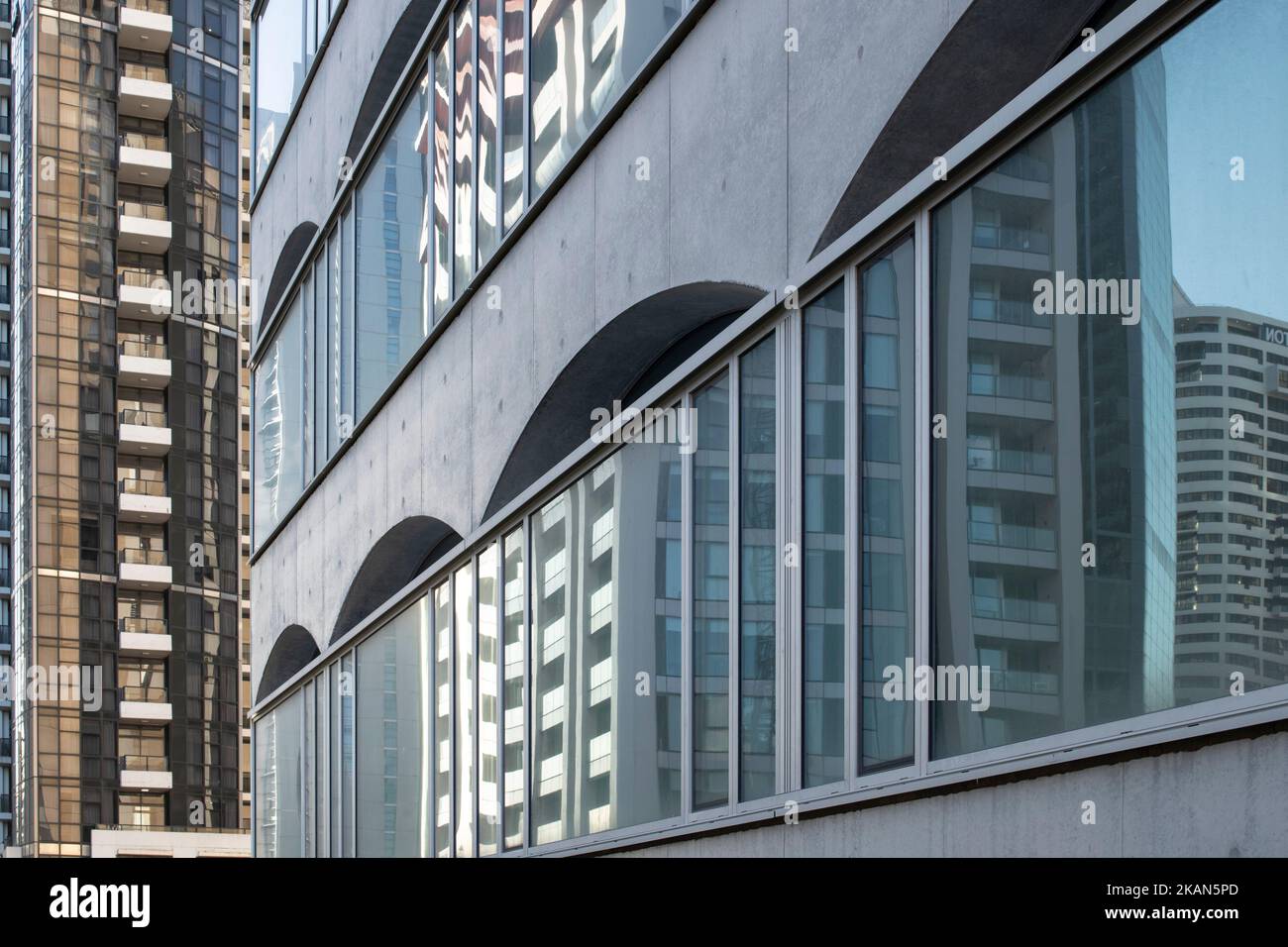 Glazing and arched detail of upper apartment levels. The Castle ...