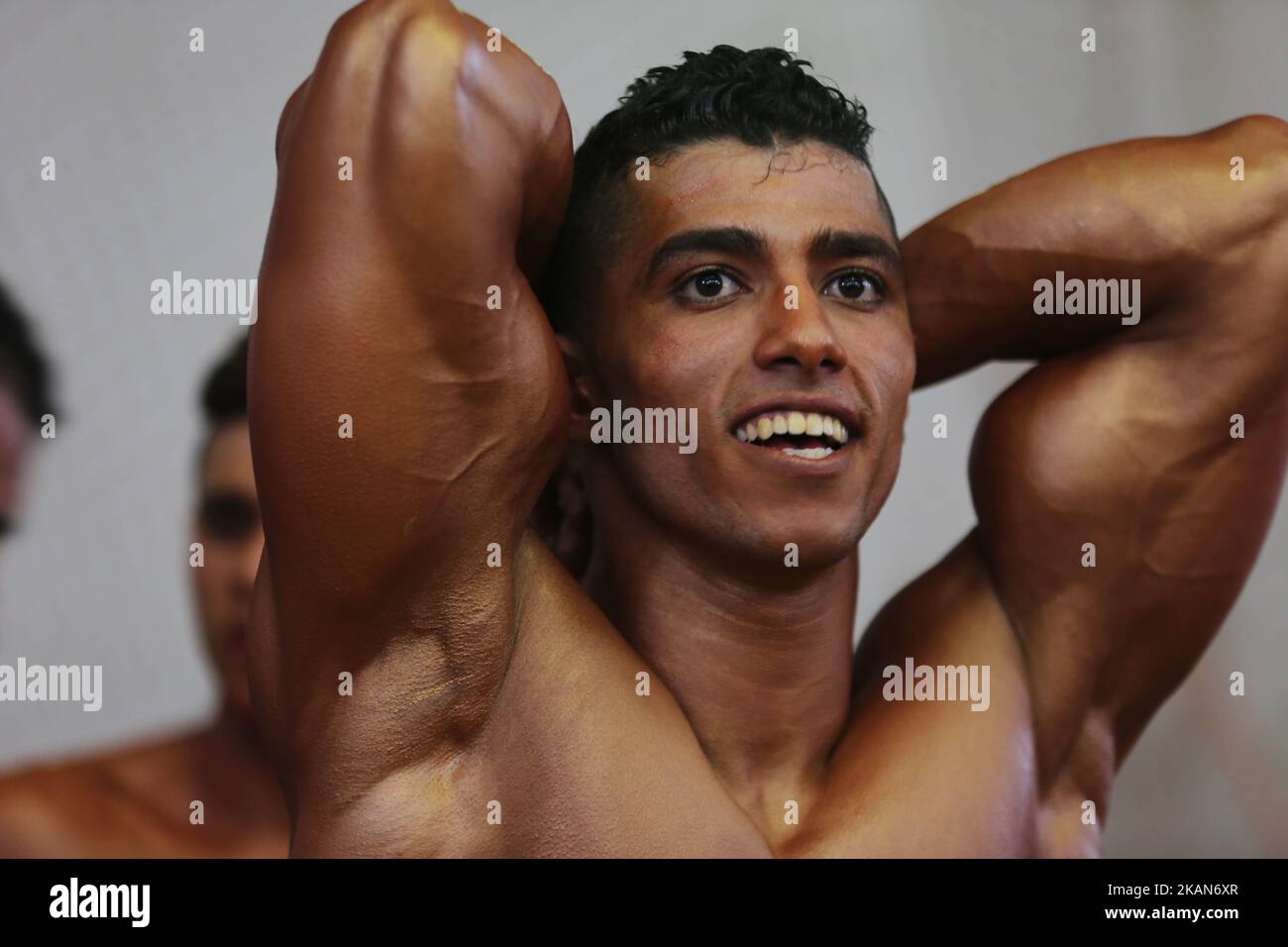 Palestinian men flex their muscles as they compete during a Gaza Strip ...