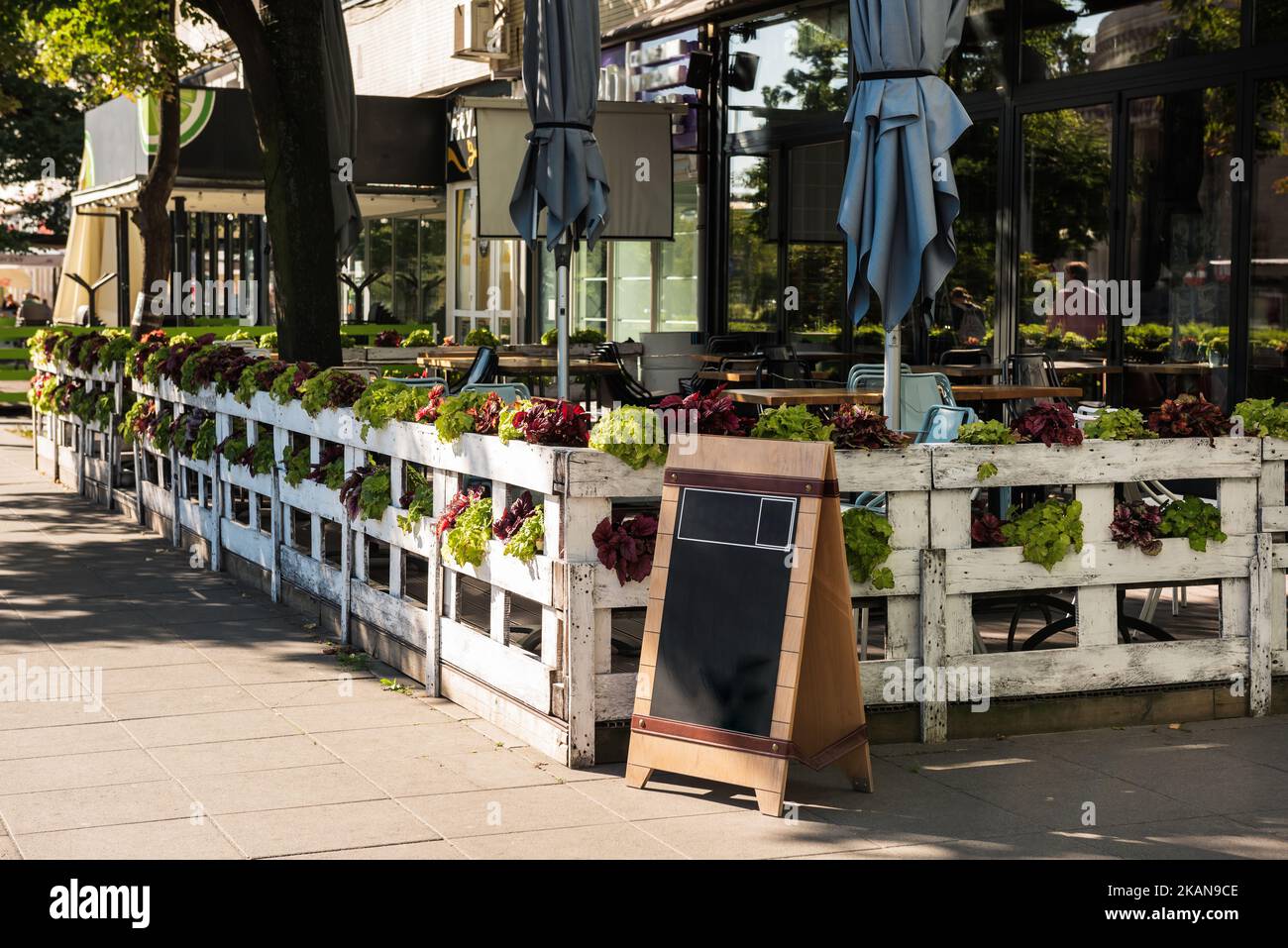The patio of the summer restaurant. The area is fenced with painted ...