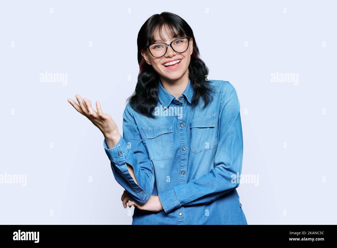 Emotional laughing young female student on white background Stock Photo ...