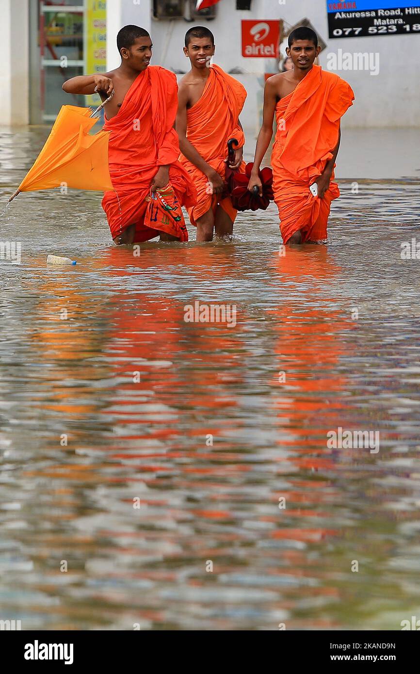 Sri Lankan novice monks walk across the Southern Expressway at Godagama ...