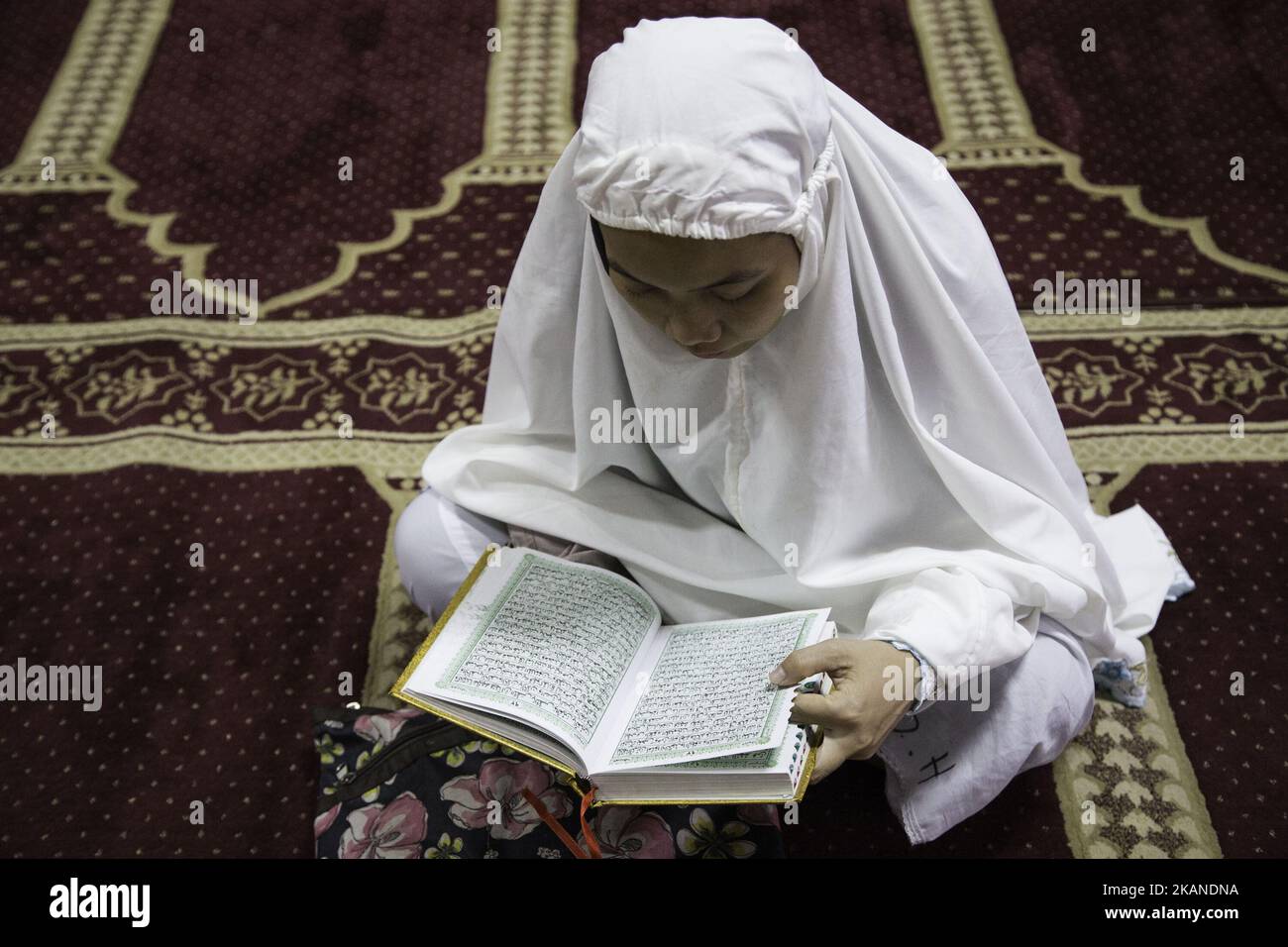 Muslims gathered at the mosque in ramadhan fasting by doing reading ...