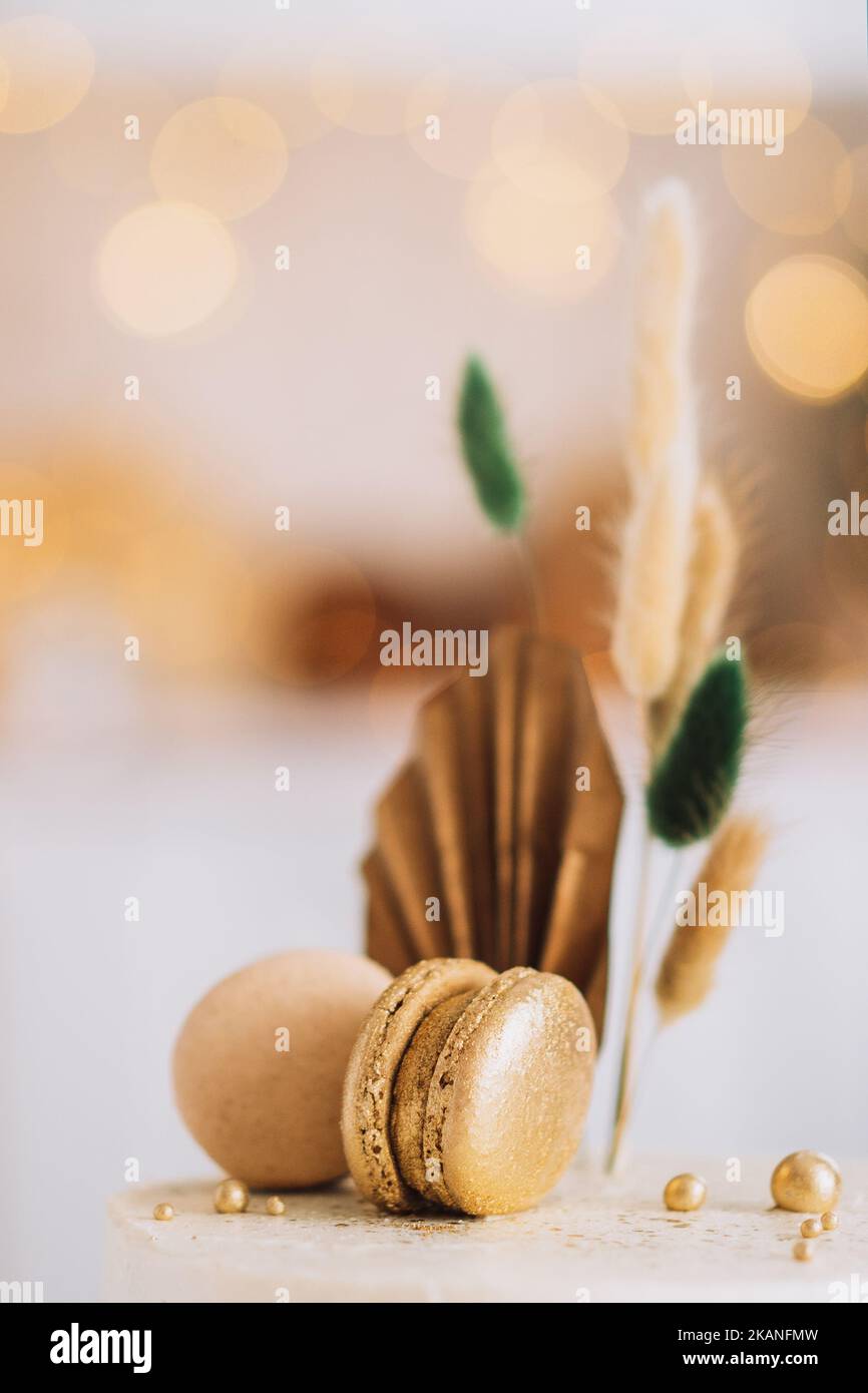 Macaroons of golden color opposite the fan and tassels Stock Photo - Alamy