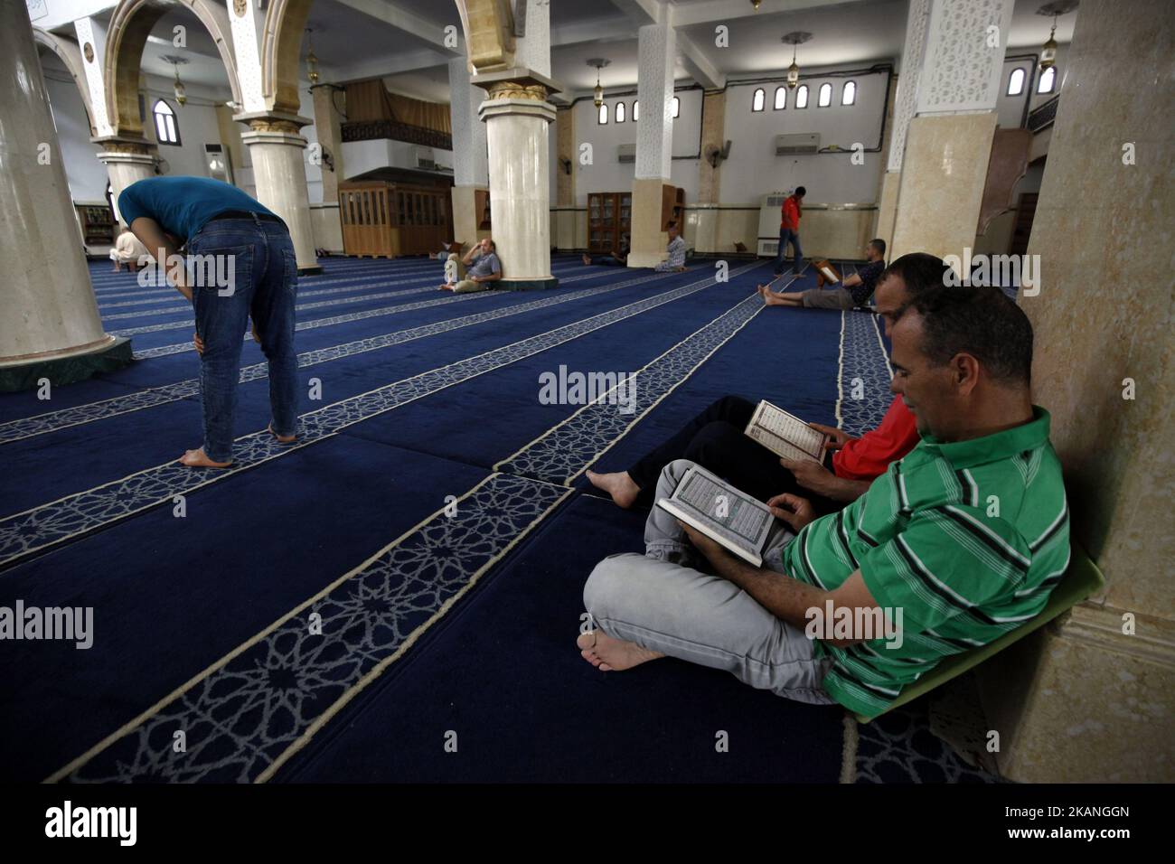 An Algerian Muslim reads the Koran in a mosque in Boufarik, Algeria, on ...