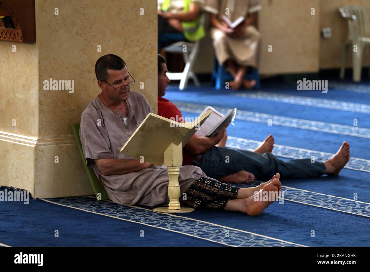 An Algerian Muslim reads the Koran in a mosque in Boufarik, Algeria, on ...