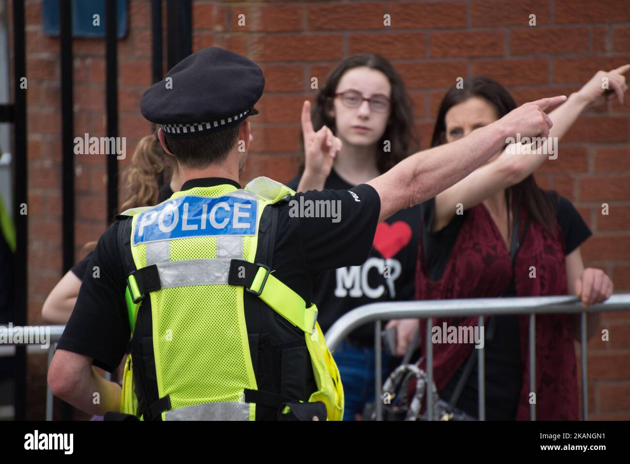 A police officer patrols as people arrive for the One Love Manchester ...