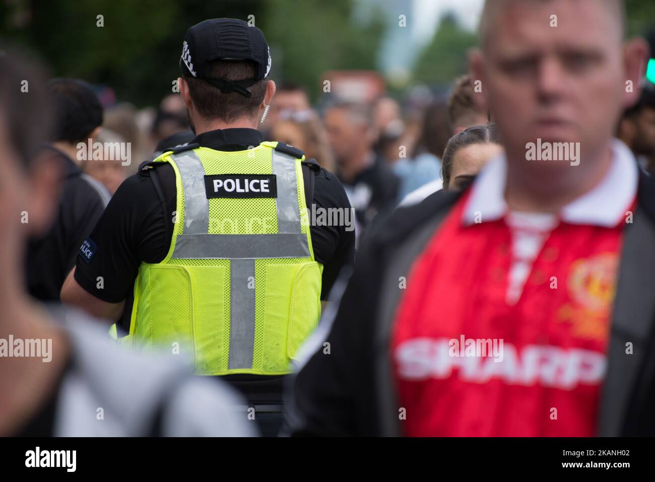 Police officers patrol as people arrive for the One Love Manchester ...