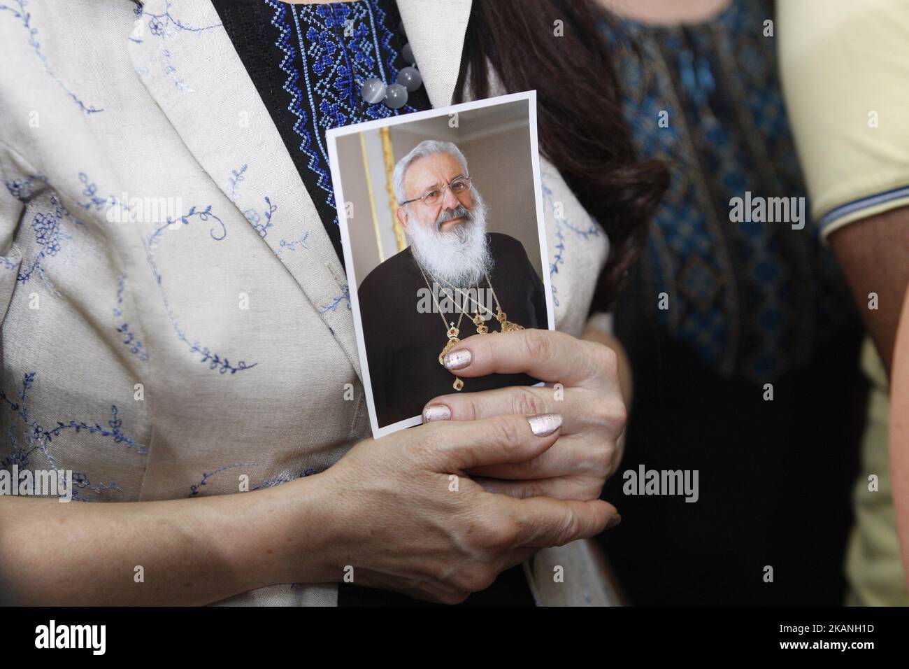 A Greek Catholic believer holds a photo of Cardinal Lubomyr Husar, ex ...