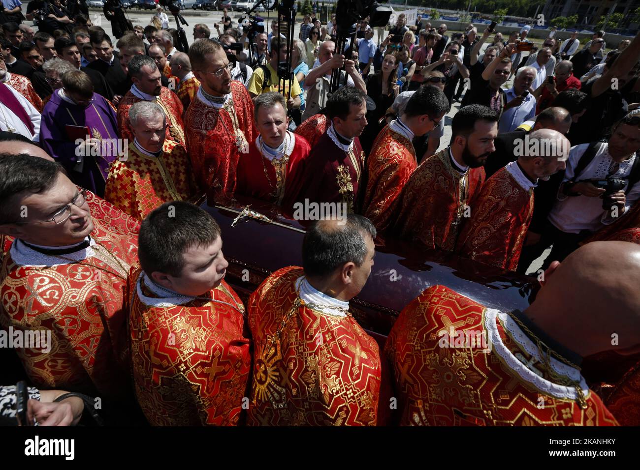 Priests carries the coffin with the body of Cardinal Husar around of ...