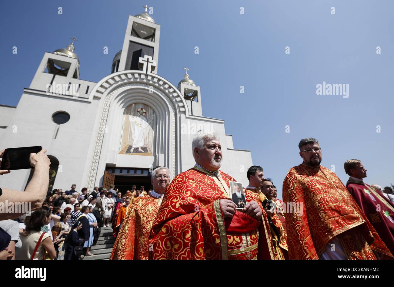 A priest carries the portrait of Lubomyr Husar during the ceremony. The ...