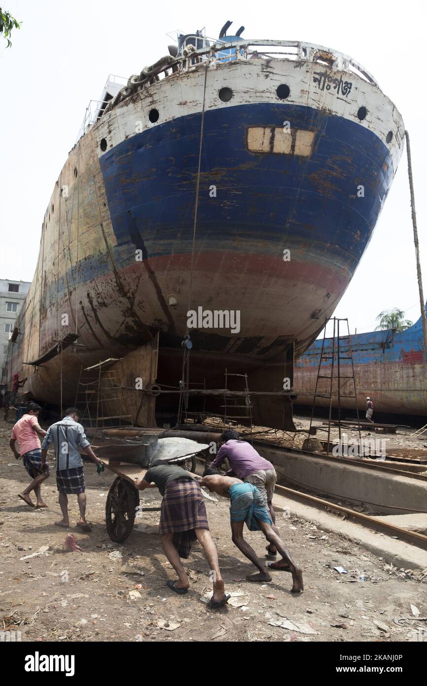 A Dock Yard laborer is working at the workshop for making parts of ship ...