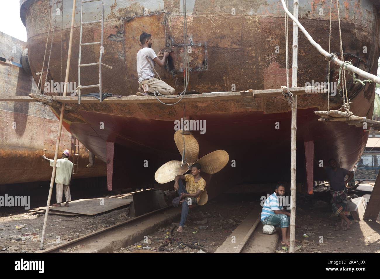A Dock Yard laborer is working at the workshop for making parts of ship ...