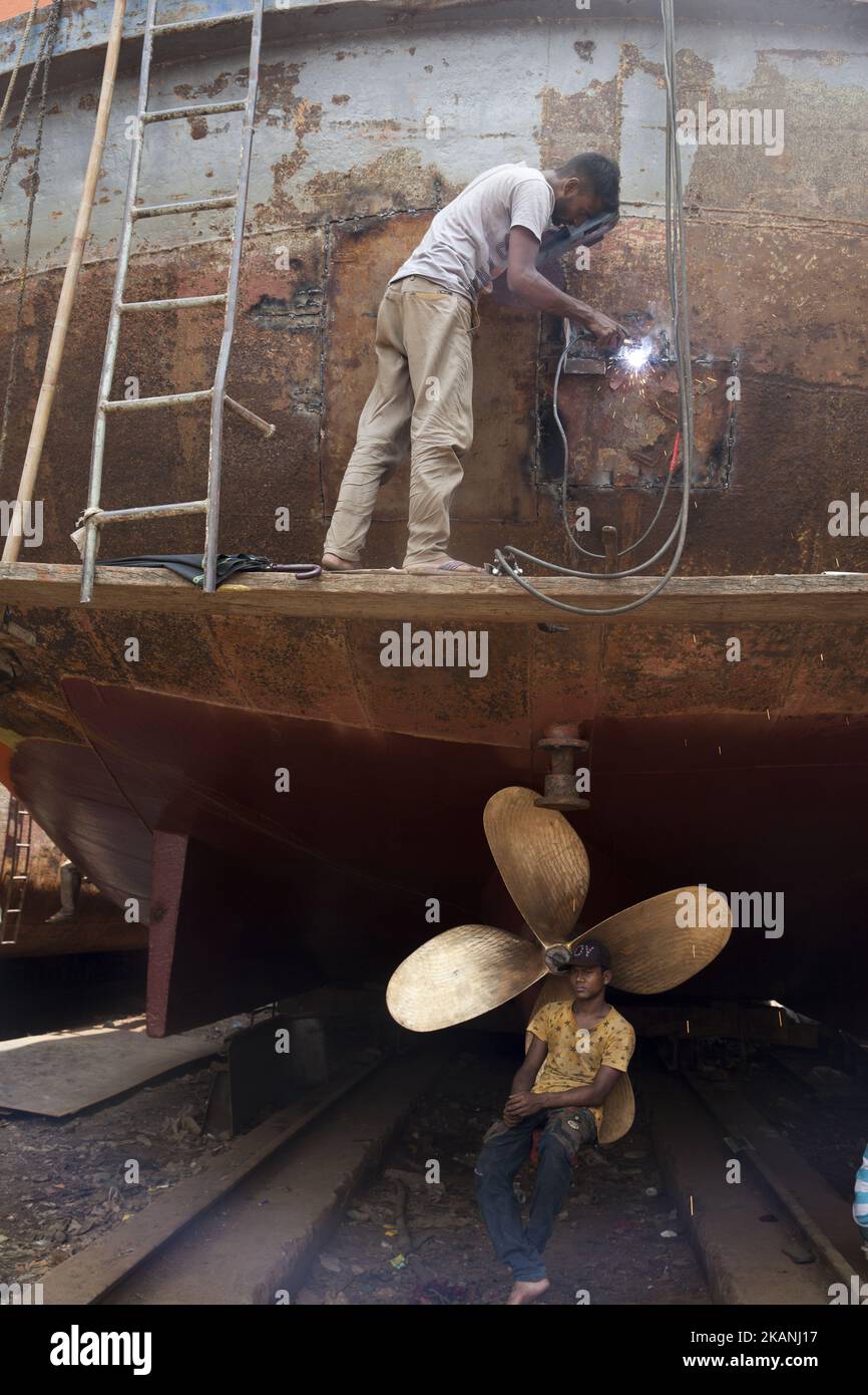 A Dock Yard laborer is working at the workshop for making parts of ship ...