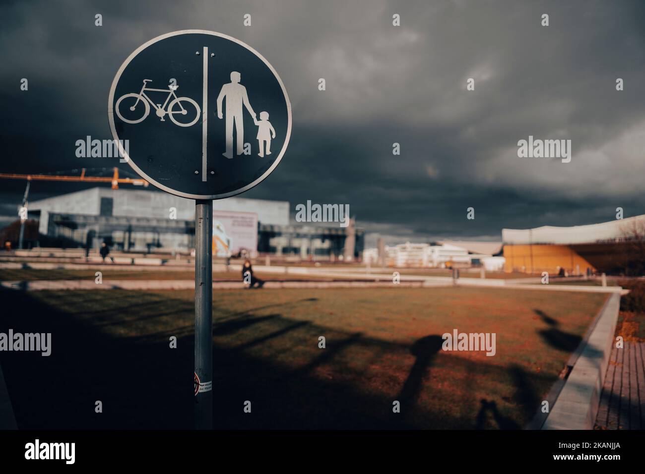 A selective shot of traffic sign on a shared use path with left lane ...