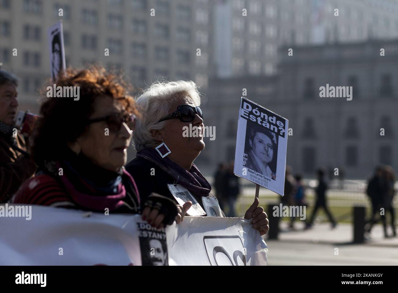Santiago, Chile. 9 June 2017. Protesters carry posters with photographs ...