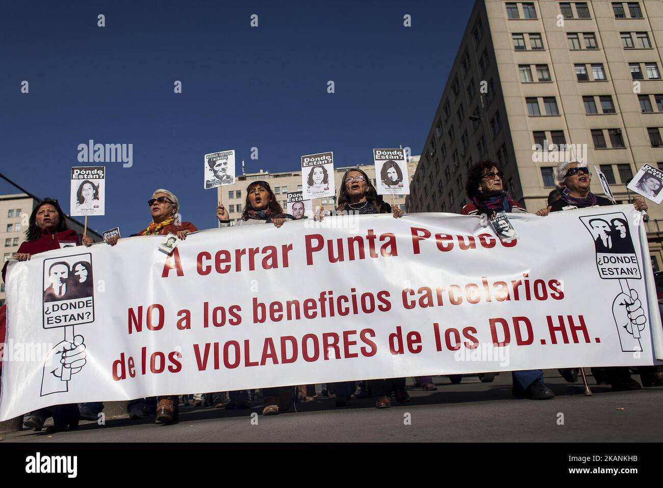 Santiago, Chile. 9 June 2017. Protesters carry posters with photographs ...