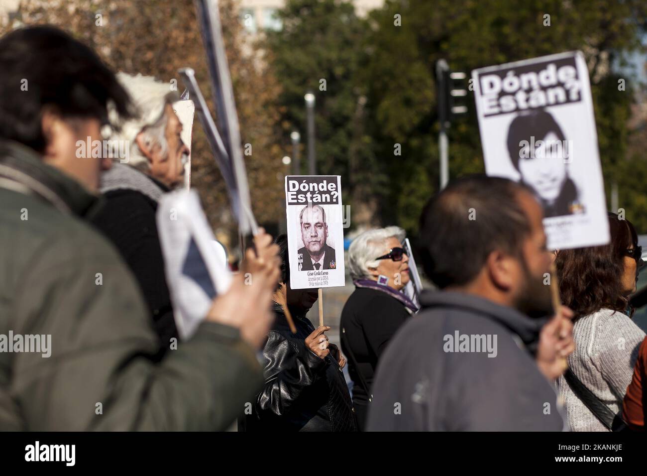 Santiago, Chile. 9 June 2017. Protesters carry posters with photographs ...