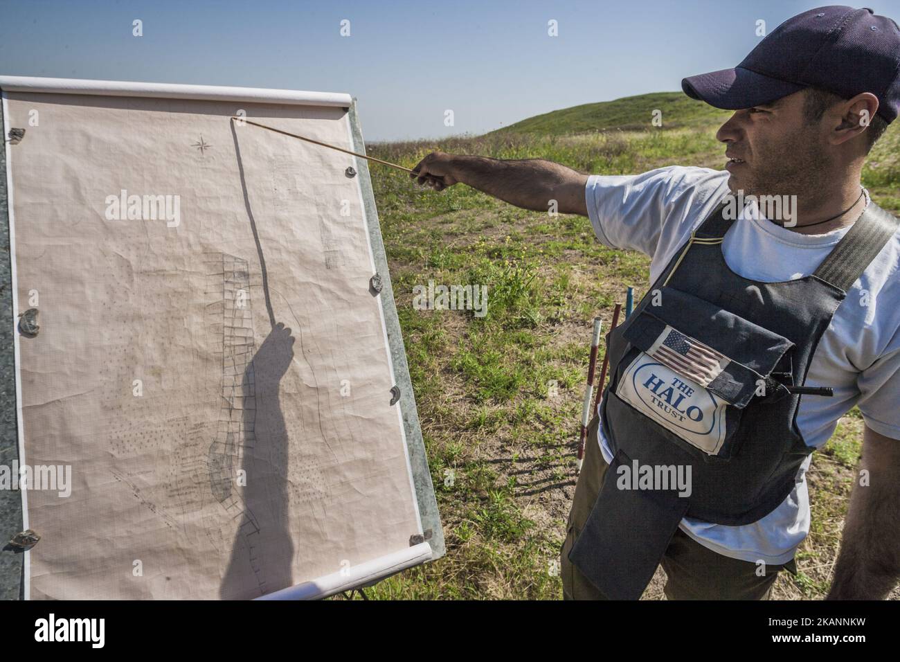 Deminers team coordinator of HALO Trust shows a landmines map of the ...