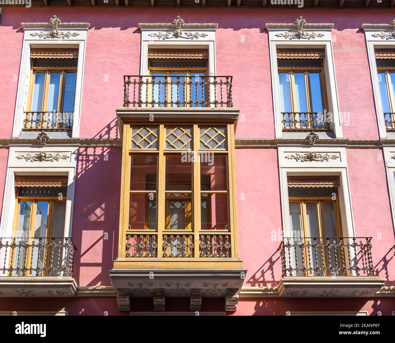 Colonial-style balcony amid old windows in the facade of a residential ...
